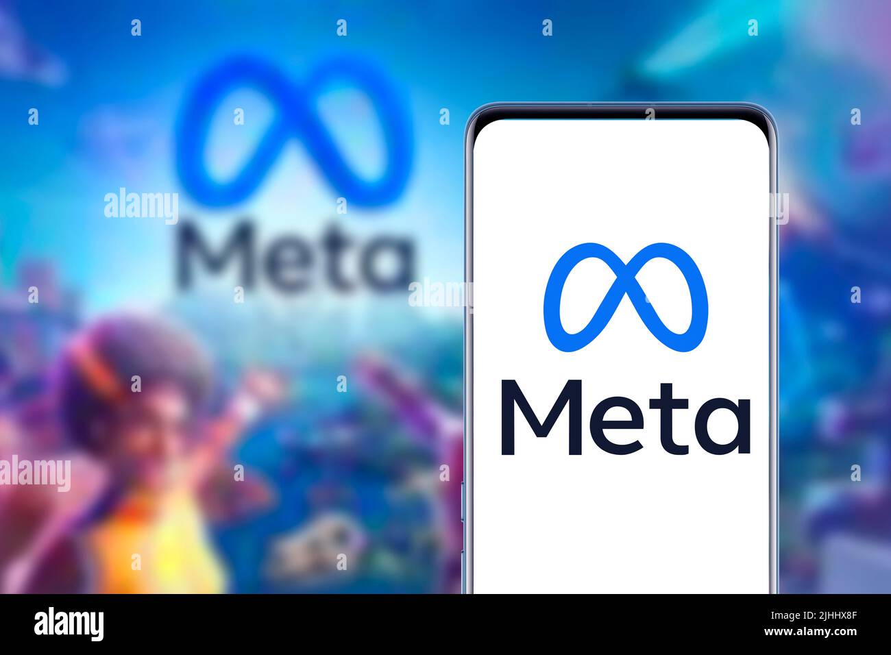 Smartphone with Meta or MetaVerse logo lies on wooden table with two ...