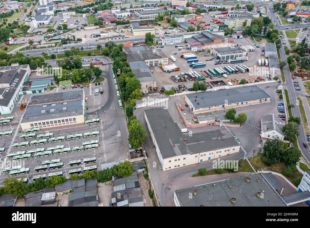 urban industrial district. bus depot with parking garage and parked ...
