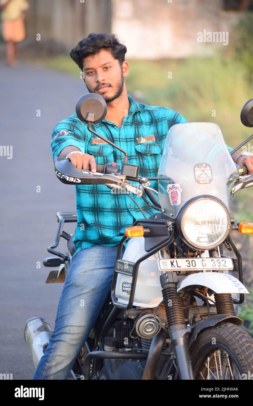 An Indian man sitting on a motorbike and posing for photo Stock Photo ...