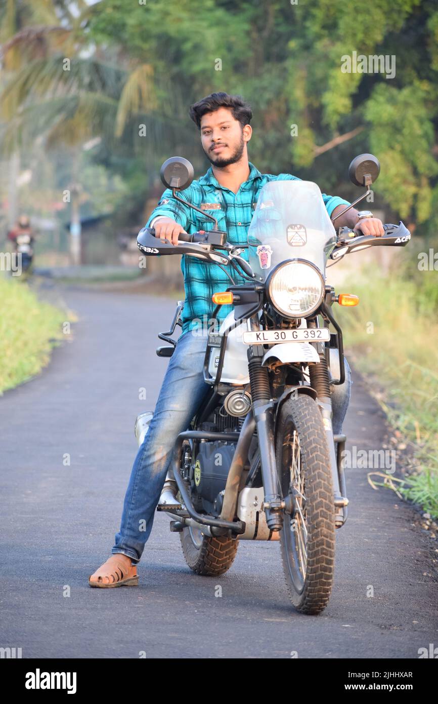 An Indian man sitting on a motorbike and posing for photo Stock Photo ...