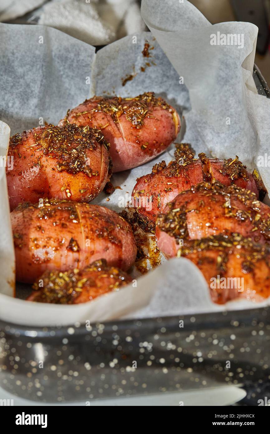 Hasselback Hedgehog potatoes, before roasting in the oven with herbs de ...