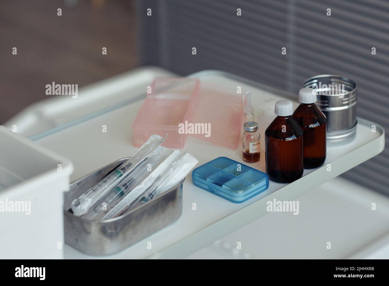 Close up of medical supplies on table in clinic with syringes and ...