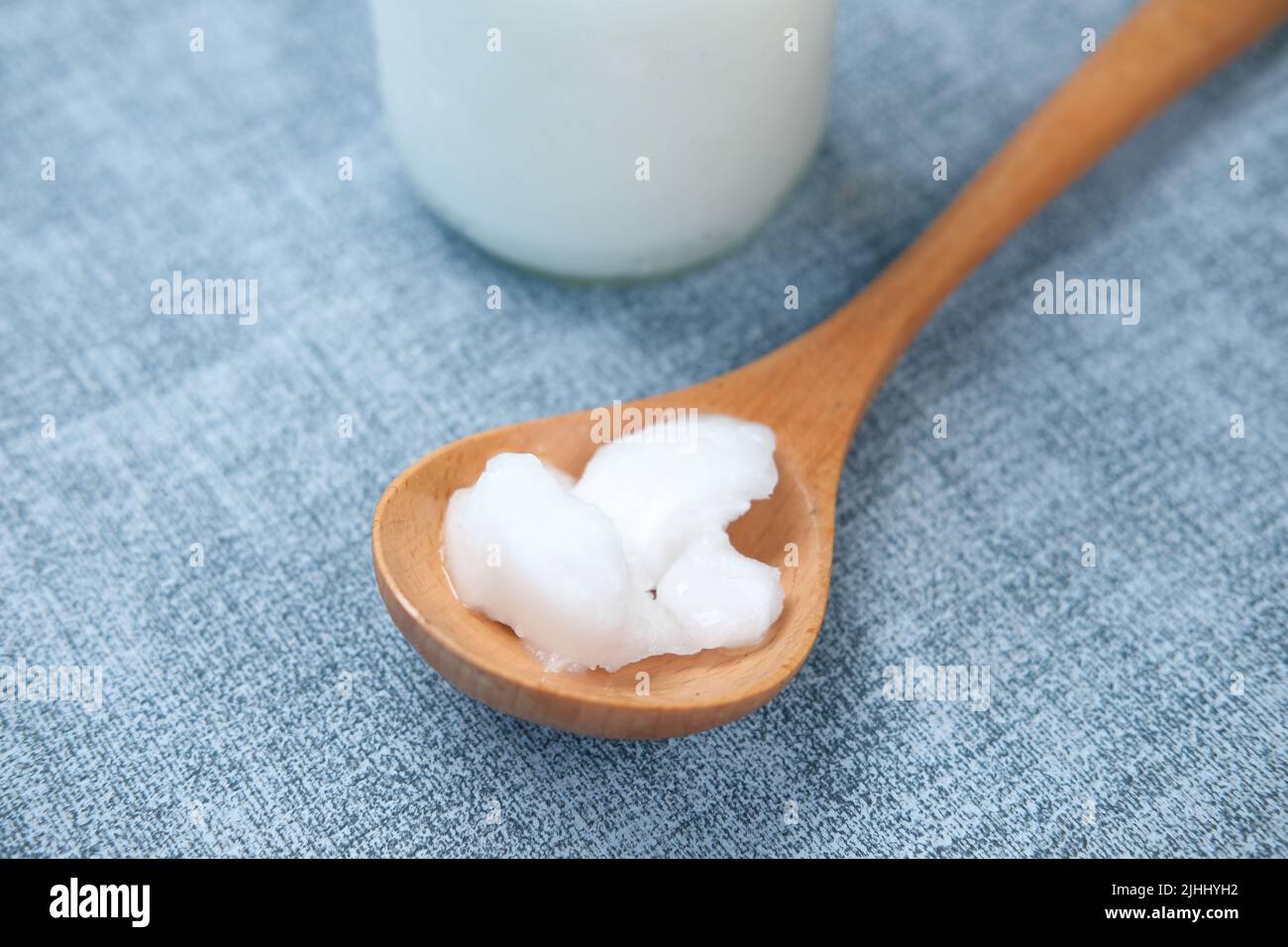 spoon with cold coconut oil on table Stock Photo - Alamy