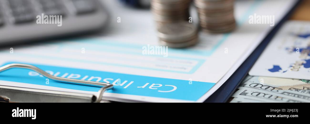 Car insurance paper, calculator and stack of coins on workplace Stock ...