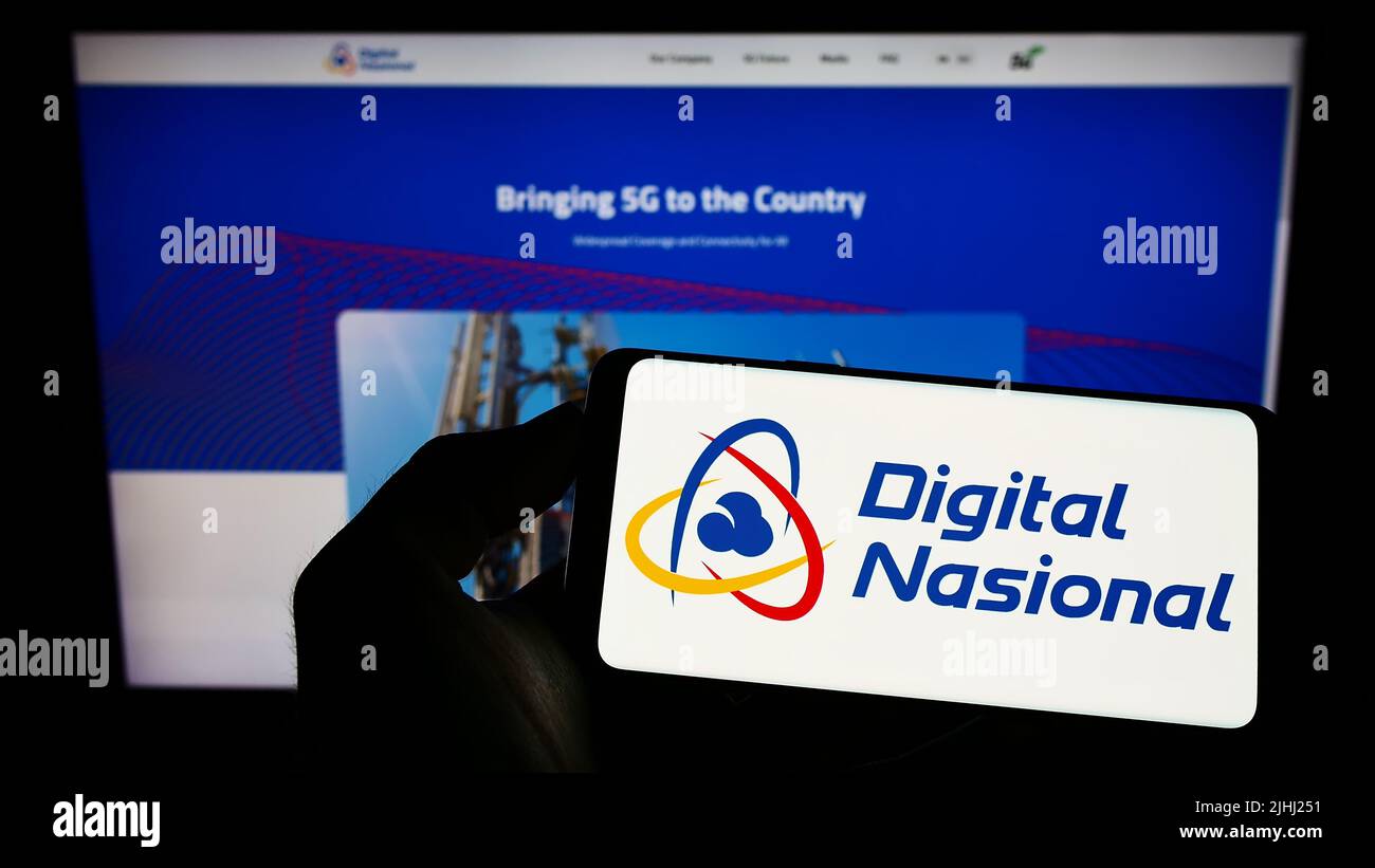 Person holding cellphone with logo of Malaysian company Digital ...