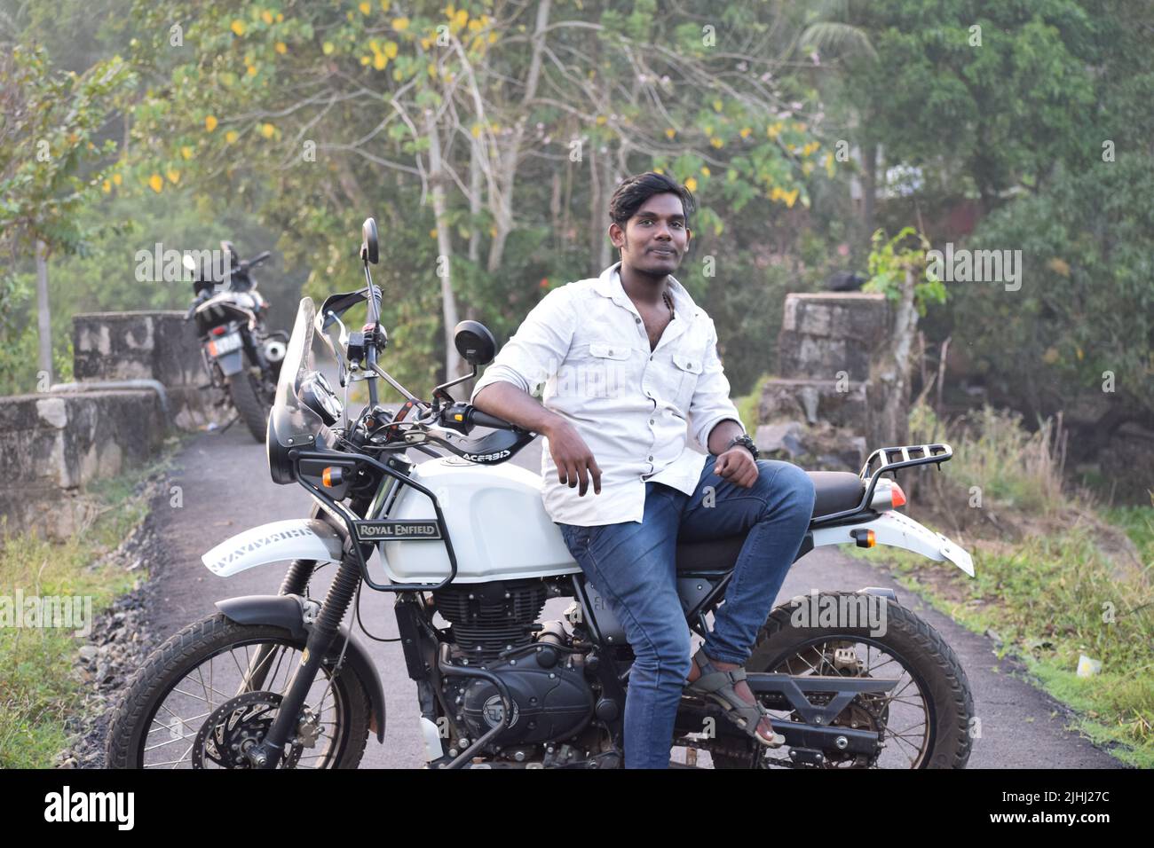 An indian young man riding a motorcycle near a paddy field Stock Photo ...