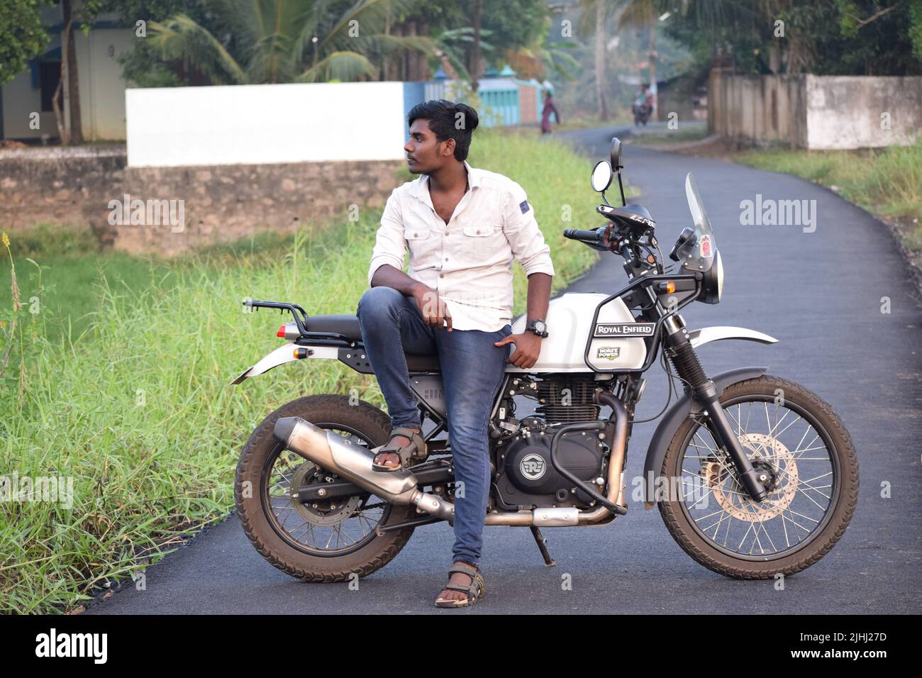 An indian young man riding a motorcycle near a paddy field Stock Photo ...