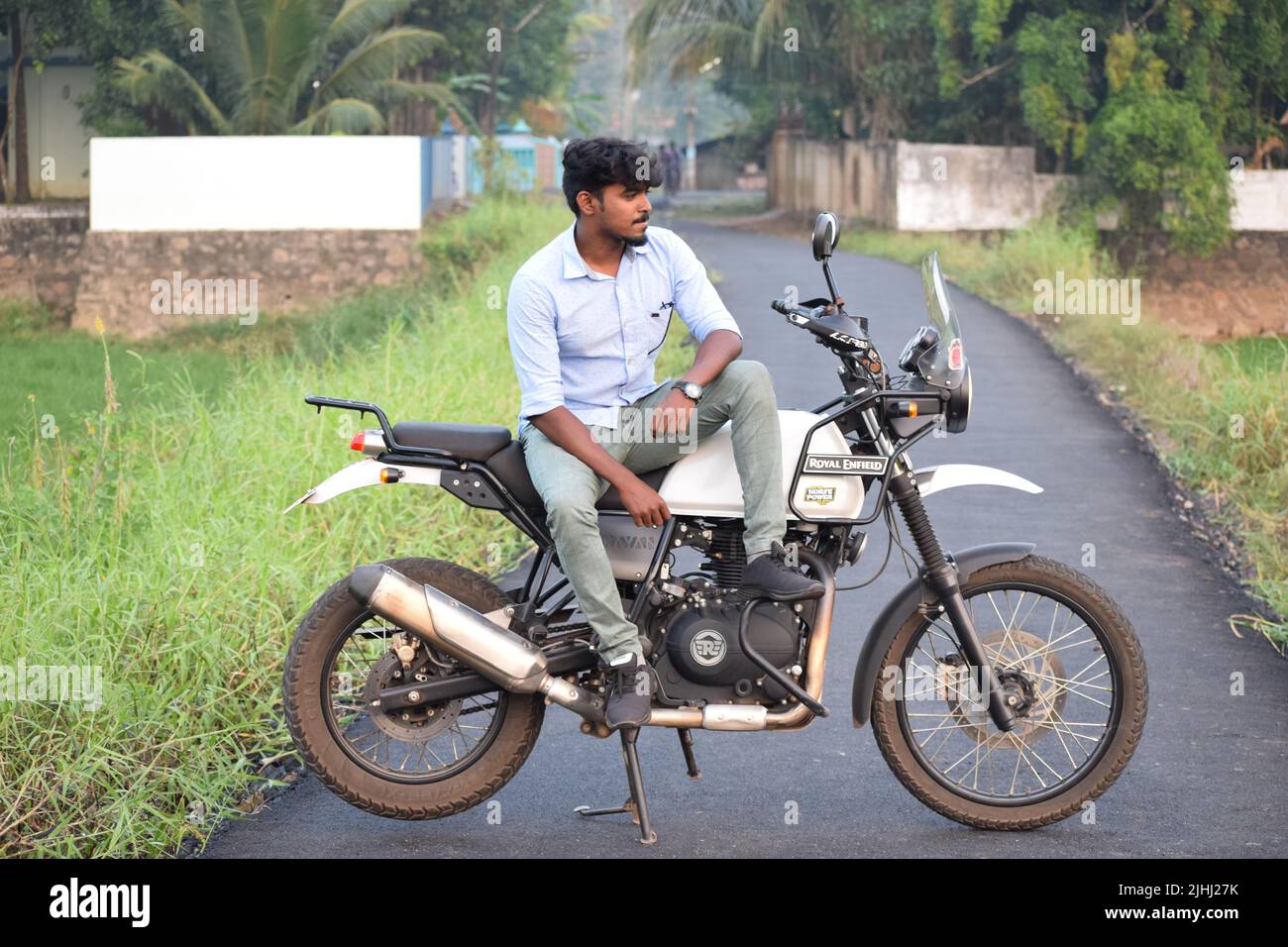 An indian young man riding a motorcycle near a paddy field Stock Photo ...
