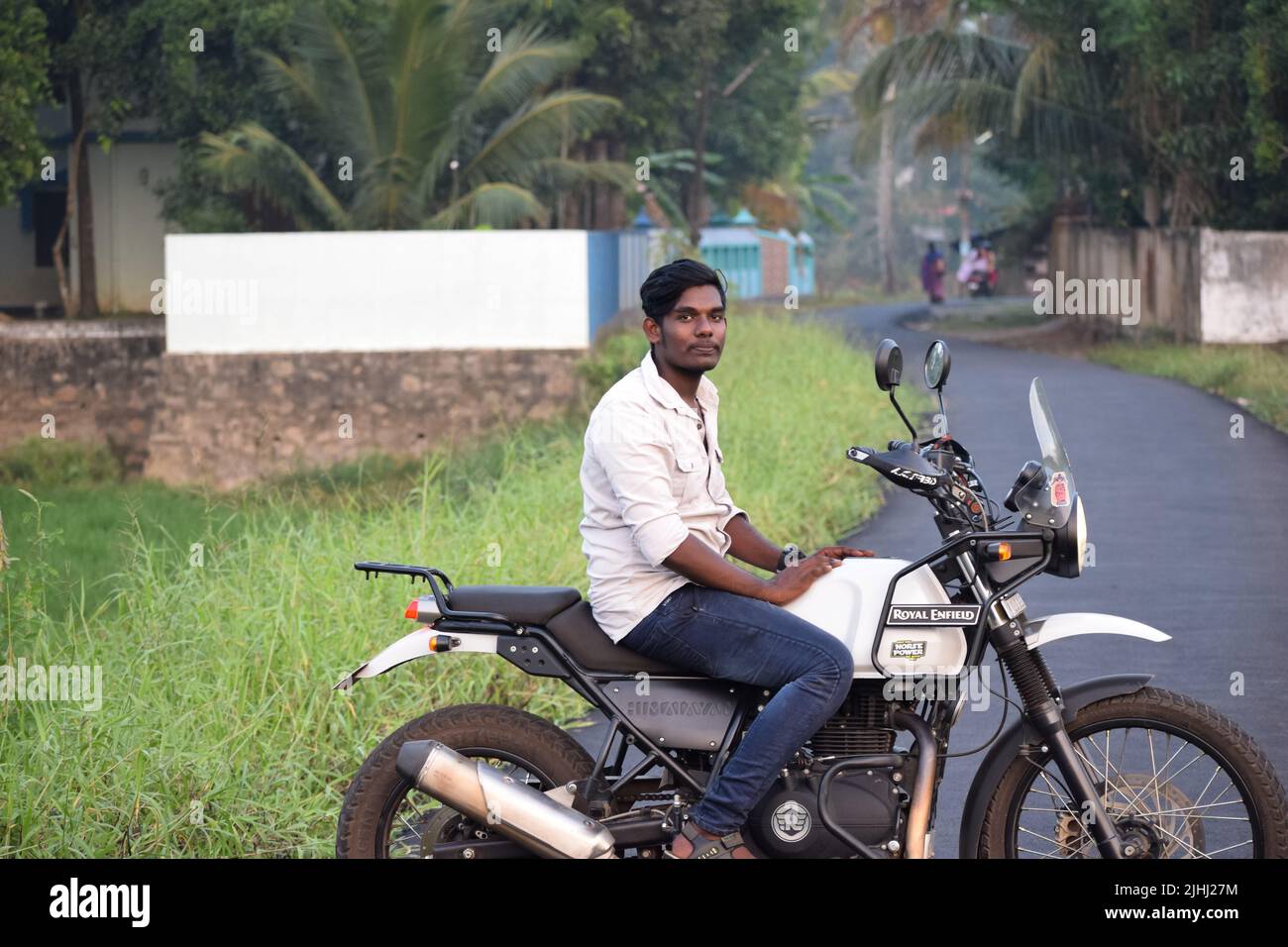 An indian young man riding a motorcycle near a paddy field Stock Photo ...