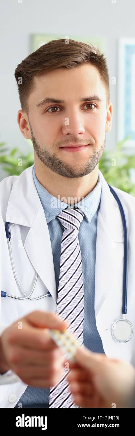 Male doctor in uniform give tablets in blister to patient Stock Photo ...