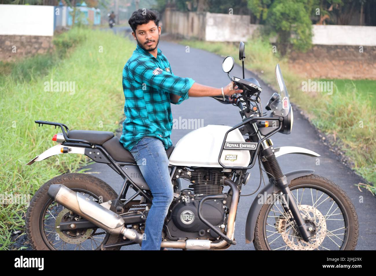 An indian young man riding a motorcycle near a paddy field Stock Photo ...