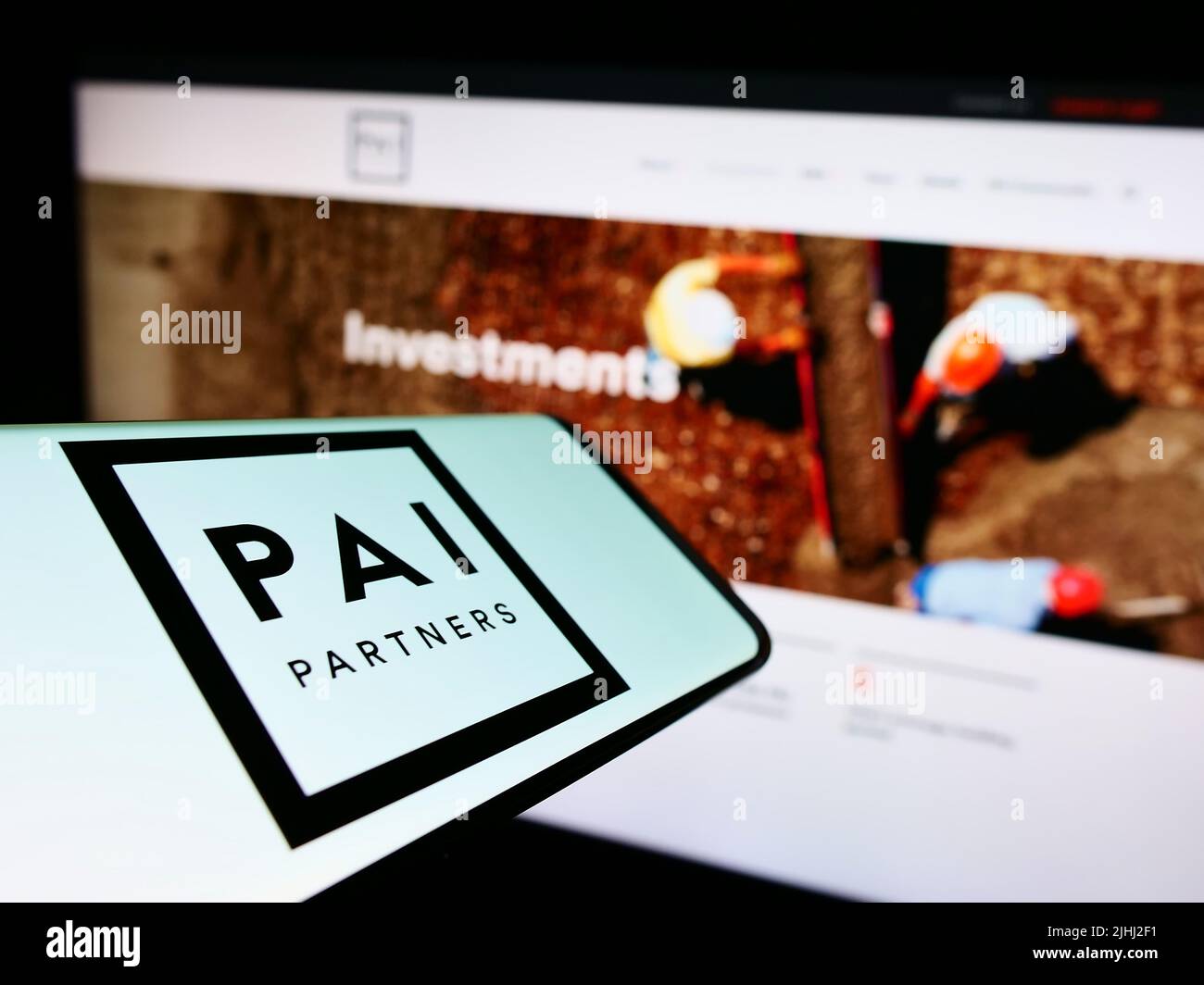 Mobile phone with logo of French investment company PAI Partners SAS on screen in front of ...