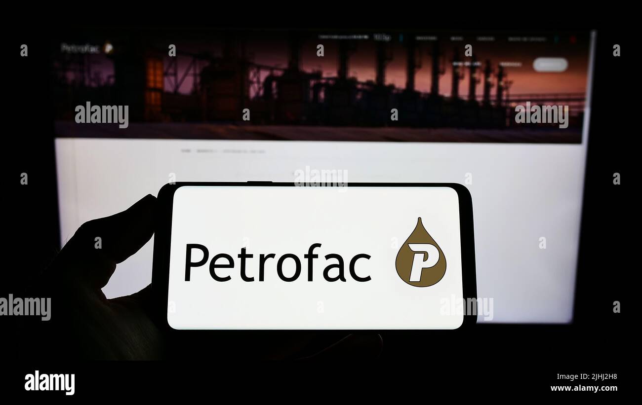 Person holding smartphone with logo of British energy services company ...