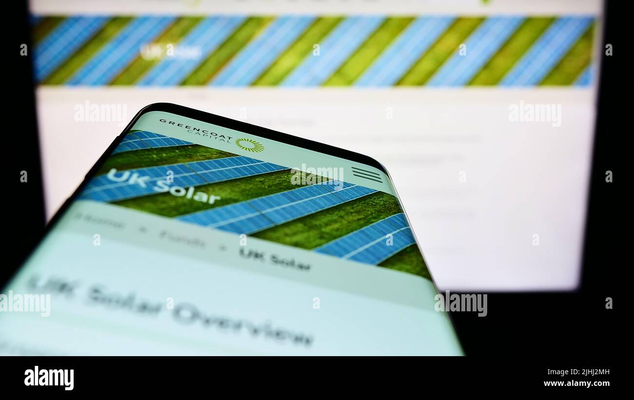Mobile phone with business website and logo of British investment ...