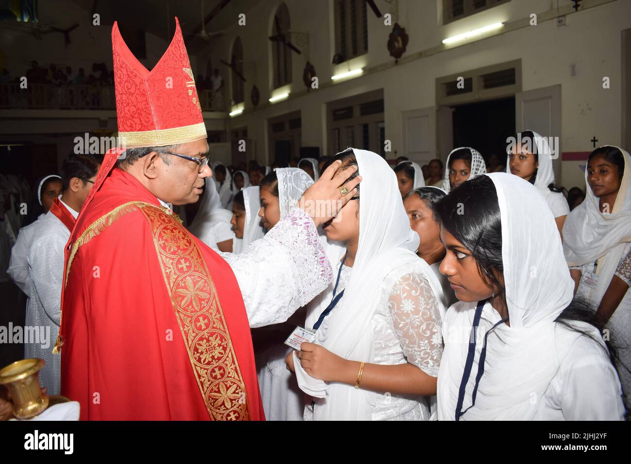Catholic bishop is giving Confirmation sacrament Stock Photo - Alamy