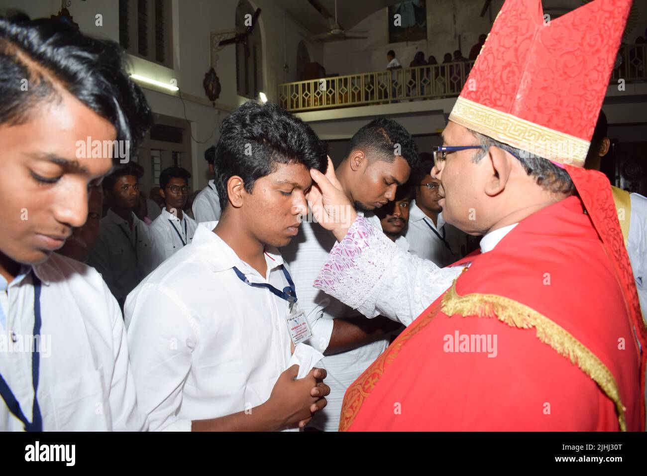 Catholic bishop is giving Confirmation sacrament Stock Photo - Alamy