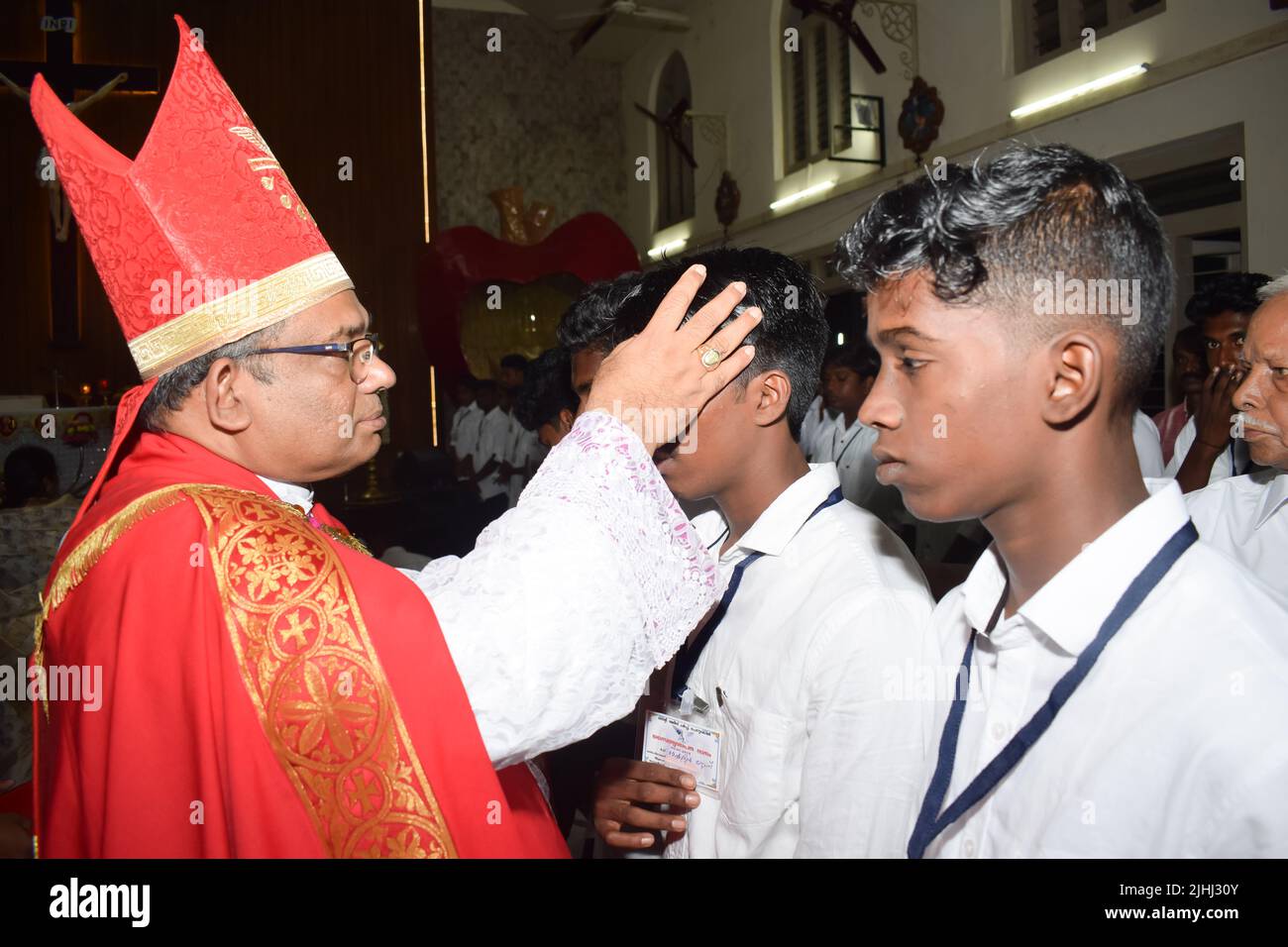 Catholic bishop is giving Confirmation sacrament Stock Photo - Alamy