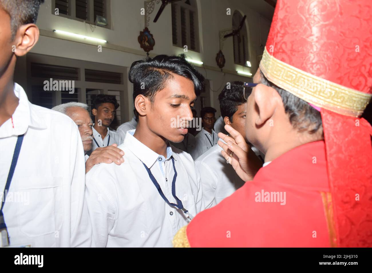 Catholic bishop is giving Confirmation sacrament Stock Photo - Alamy