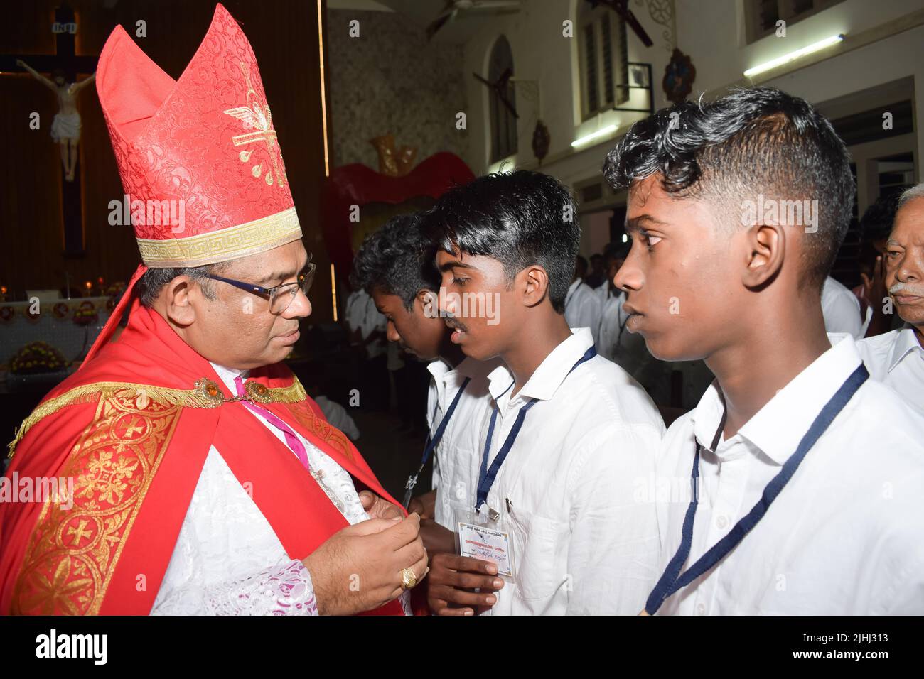 Catholic bishop is giving Confirmation sacrament Stock Photo - Alamy