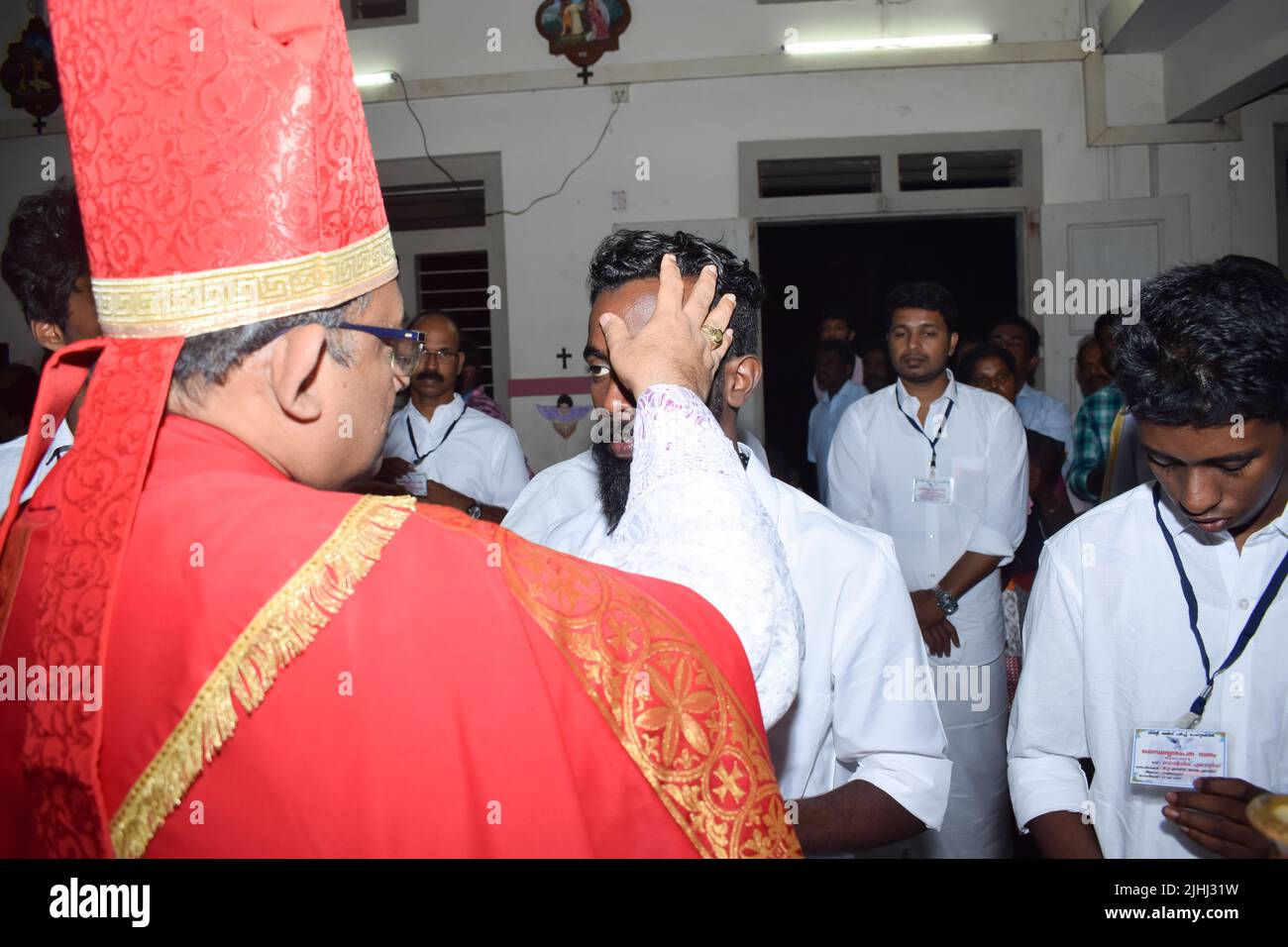 Catholic bishop is giving Confirmation sacrament Stock Photo - Alamy