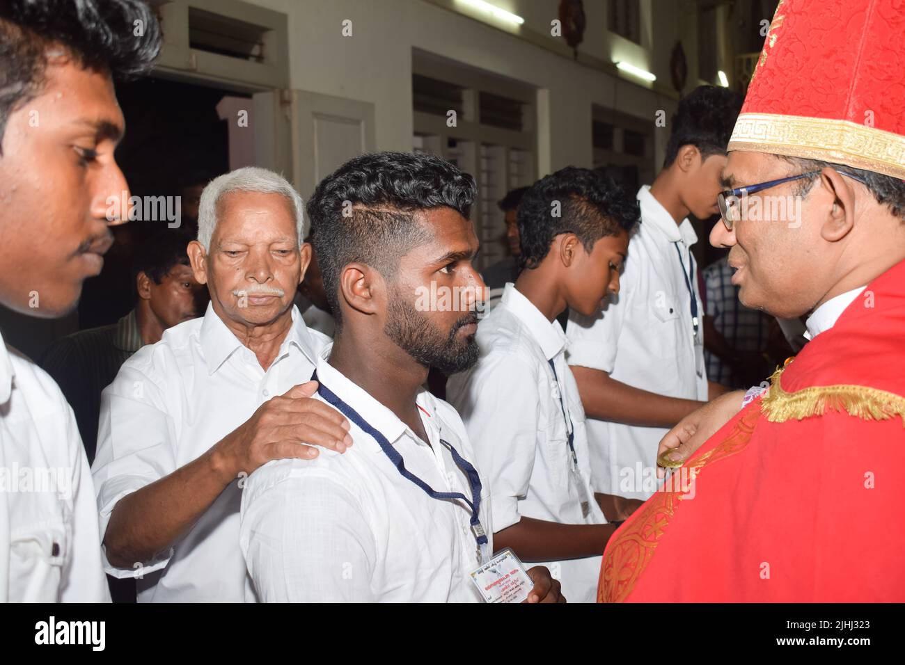 Catholic bishop is giving Confirmation sacrament Stock Photo - Alamy