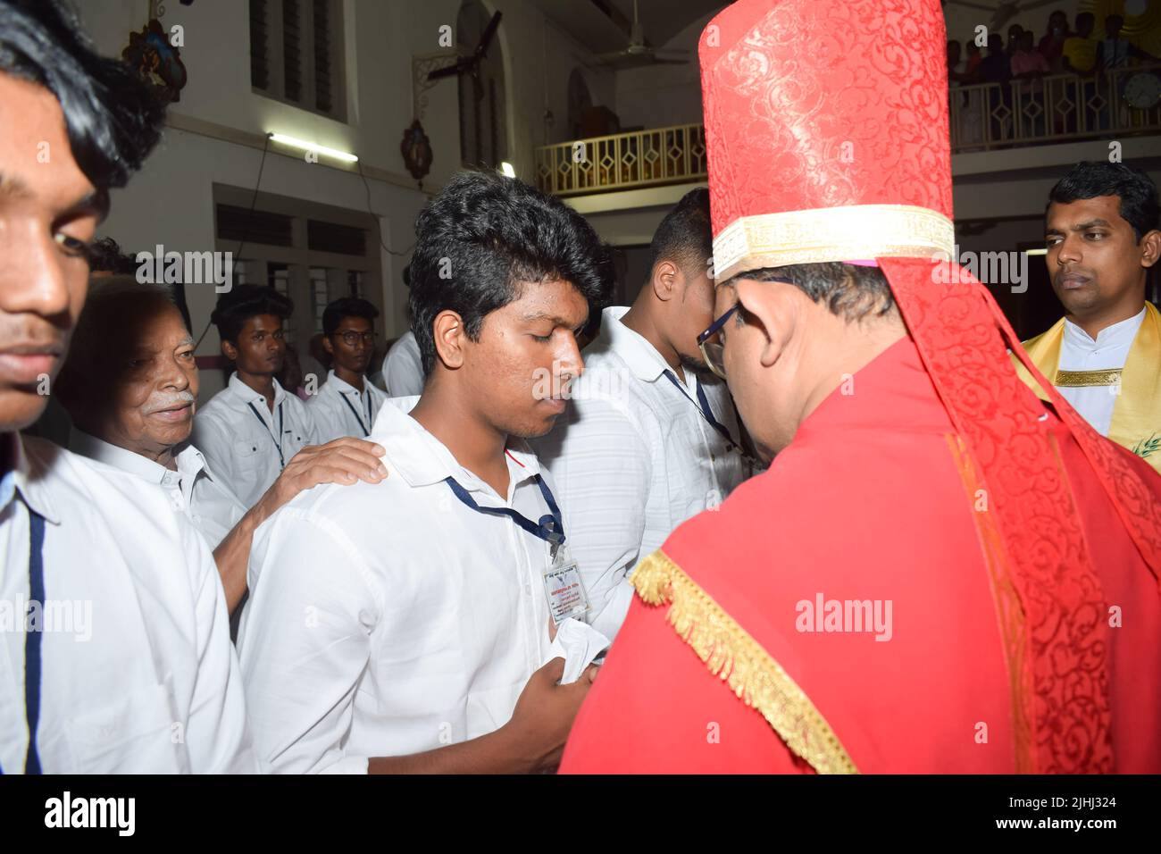 Catholic bishop is giving Confirmation sacrament Stock Photo - Alamy
