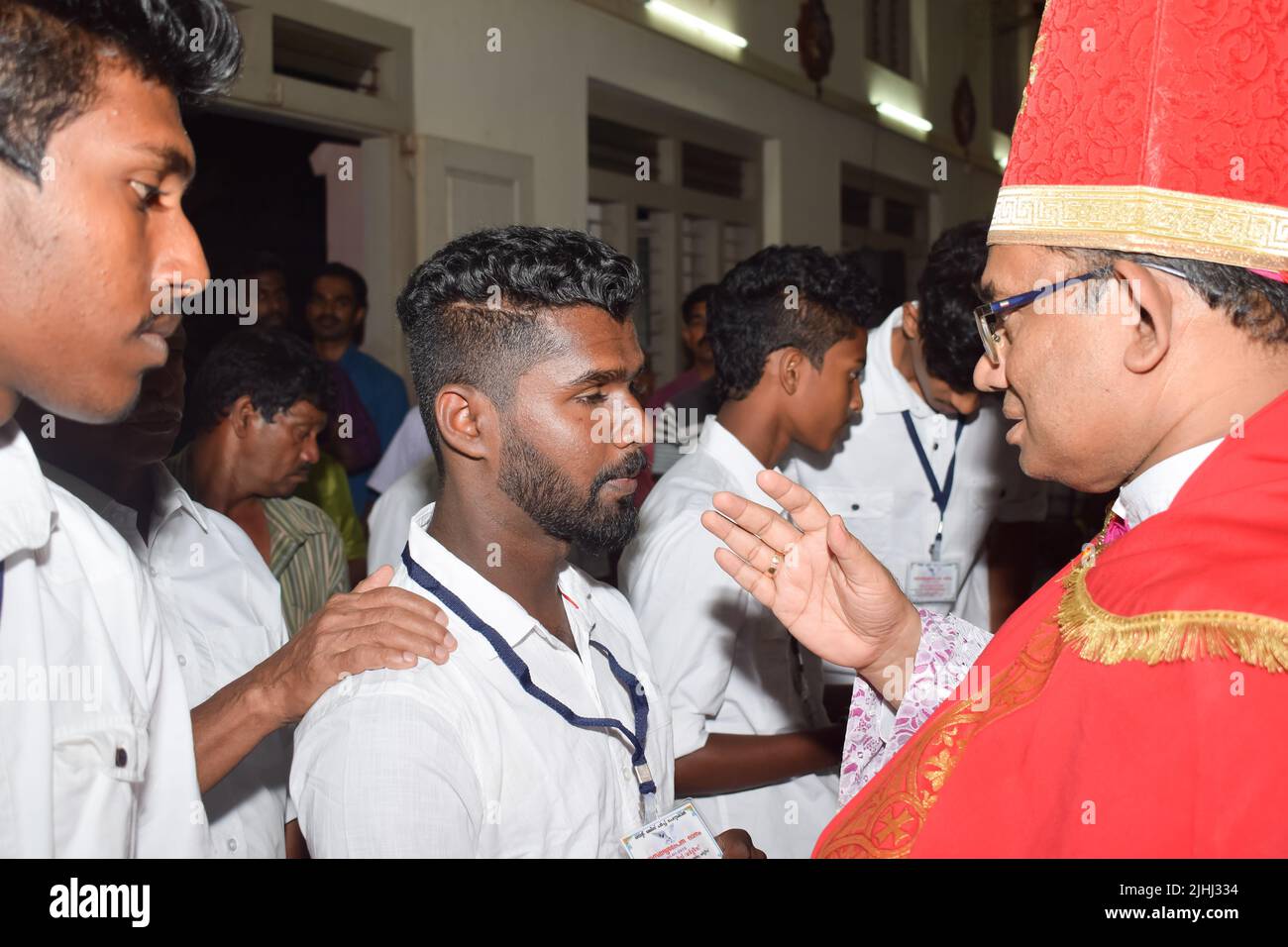 Catholic bishop is giving Confirmation sacrament Stock Photo - Alamy