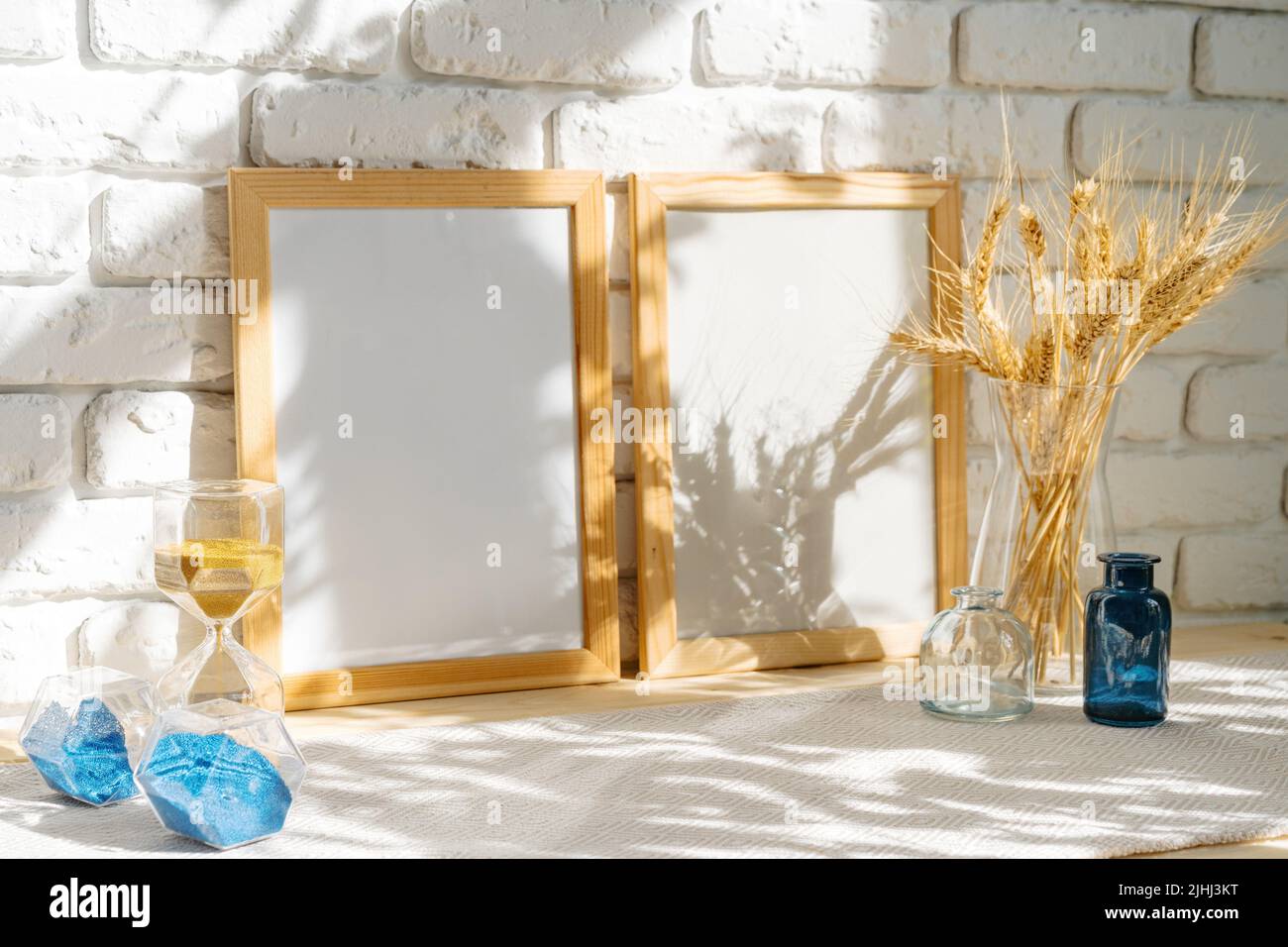 Photo frames on a brick wall background on the table with wheat ears in ...