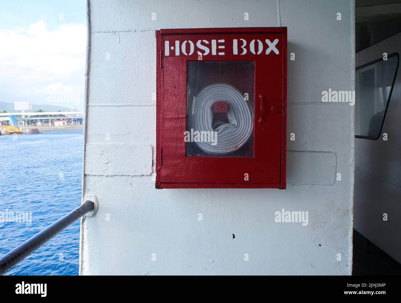 fire hose stored in a red box on a ferry Stock Photo - Alamy