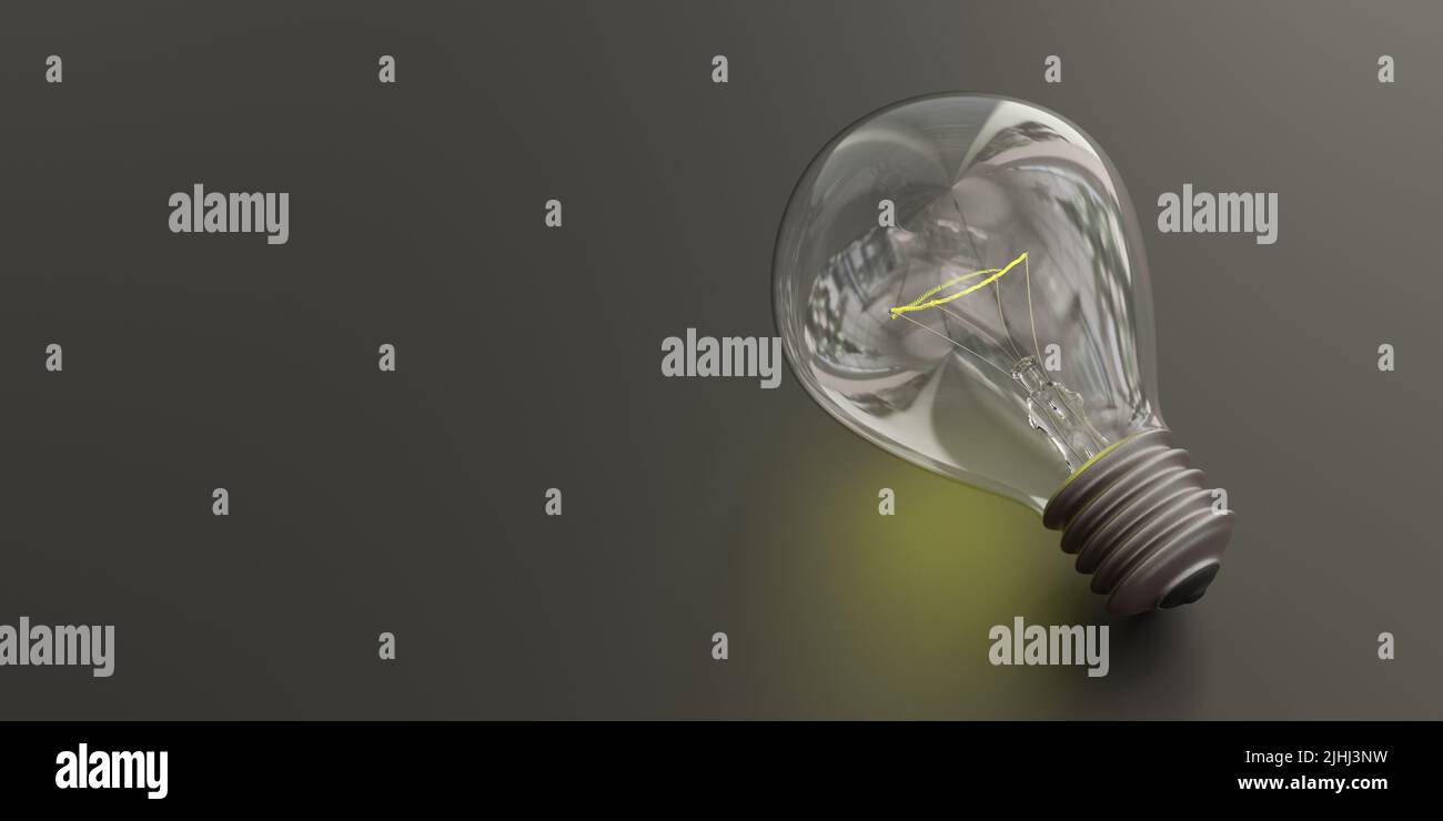Light bulb with yellow wire on empty grey background. Transparent glass ...