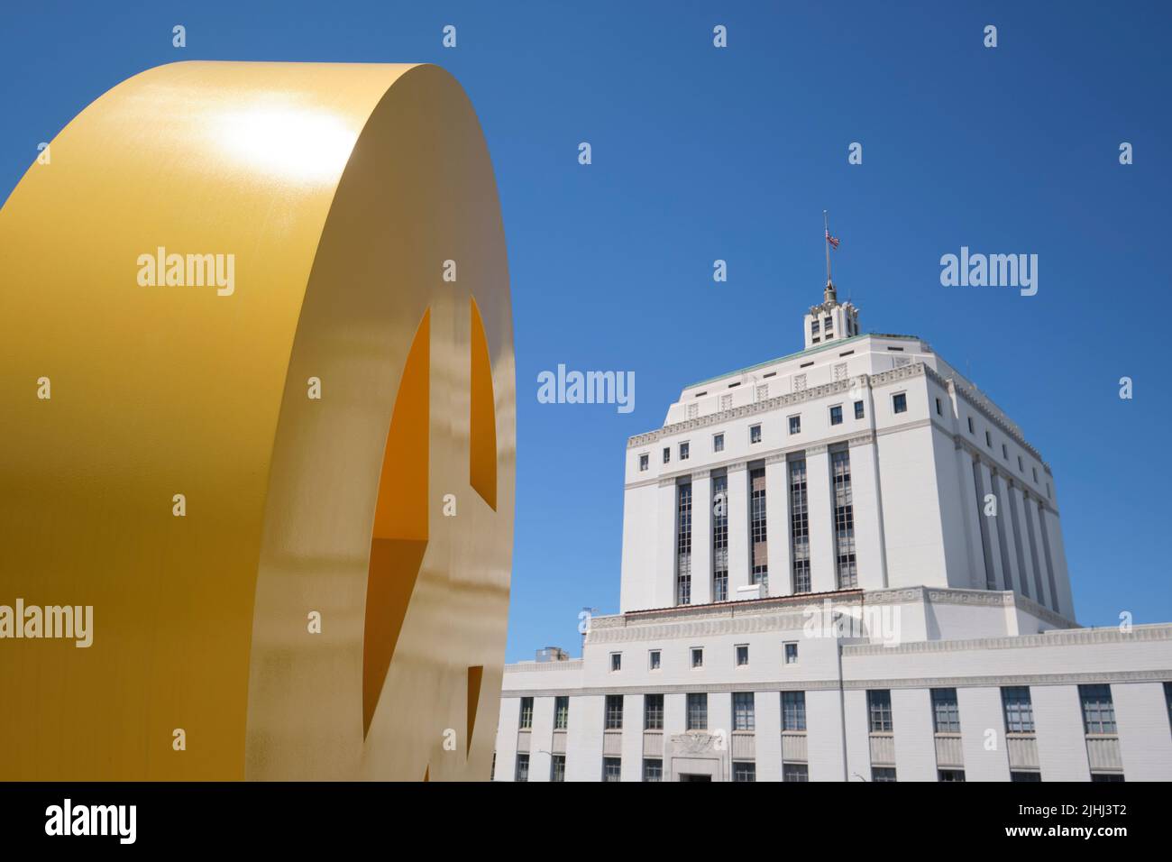 A view of the County Courthouse with a yellow metal peace sign ...