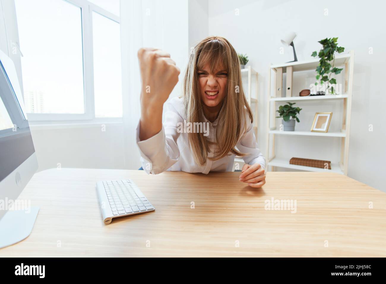 Angry evil blonde businesswoman screaming to subordinates shaking fist ...