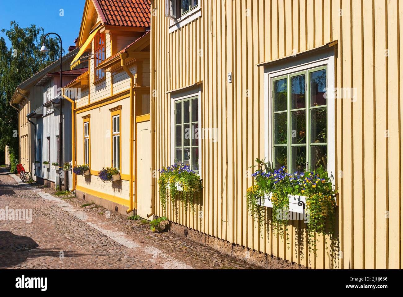 Idyllic city street with flower boxes on the wooden houses Stock Photo ...