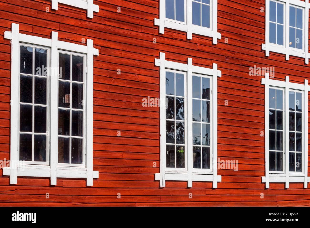 Beautiful old red wooden facade with windows Stock Photo - Alamy