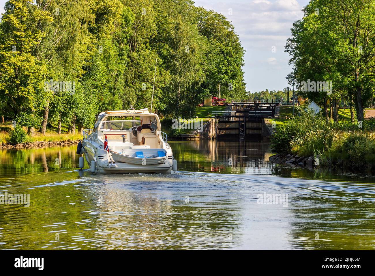 Motorboat on its way into a lock in the Göta Canal, Sweden Stock Photo ...