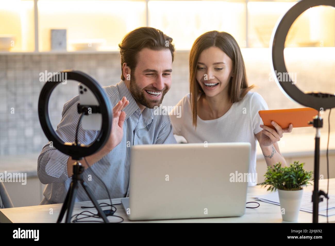 Two vloggers having online tutorial and looking involved Stock Photo ...