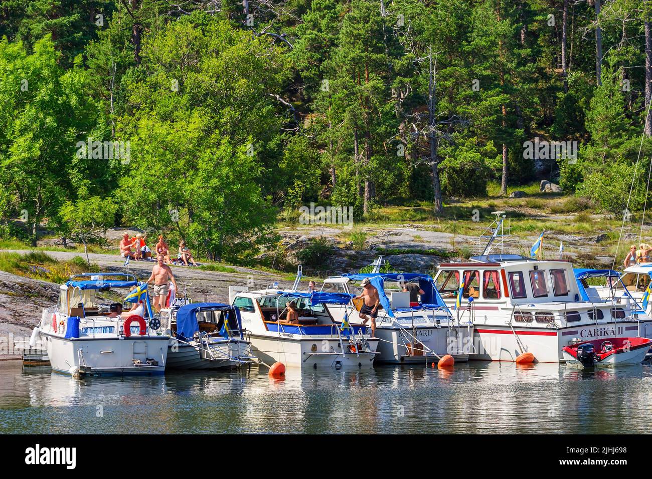 Boats in a nature harbor by a beach Stock Photo - Alamy