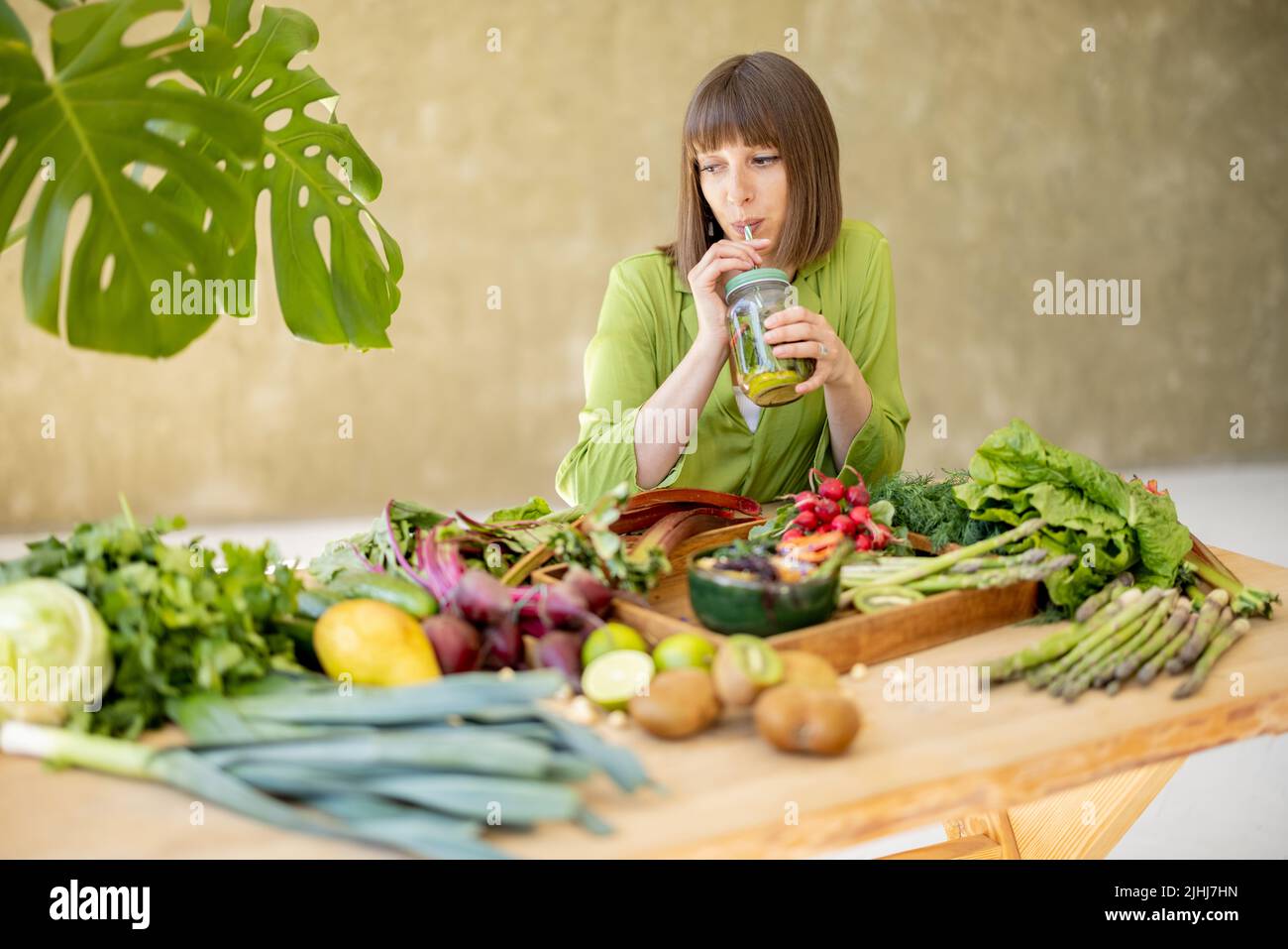 Woman with lots of fresh food ingredients indoors Stock Photo - Alamy