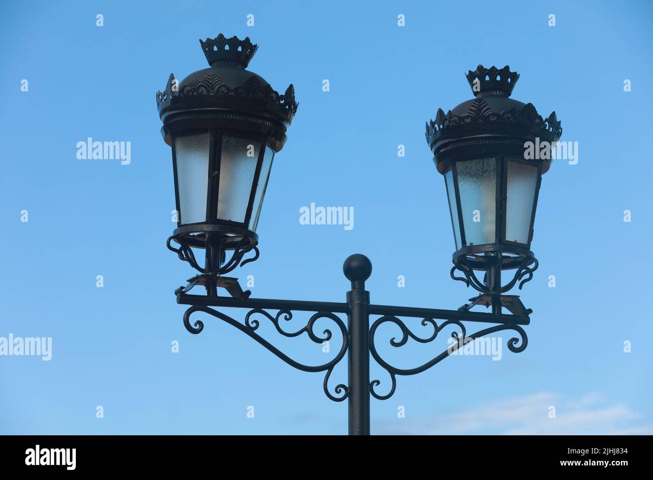 Lantern with yellow warm light on facade of building. Twilight on city ...
