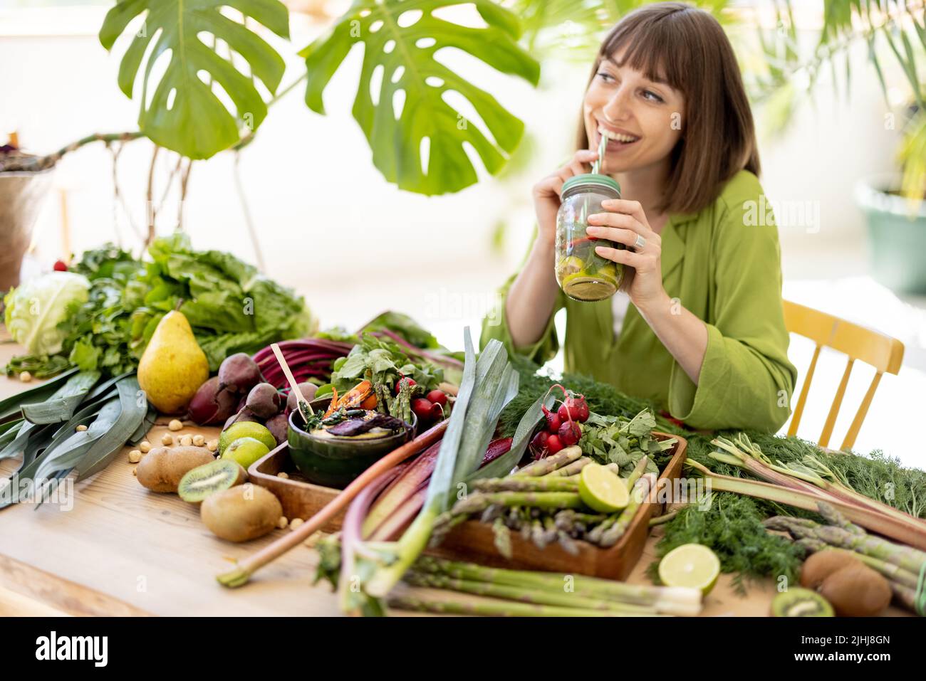 Woman with lots of fresh food ingredients indoors Stock Photo - Alamy