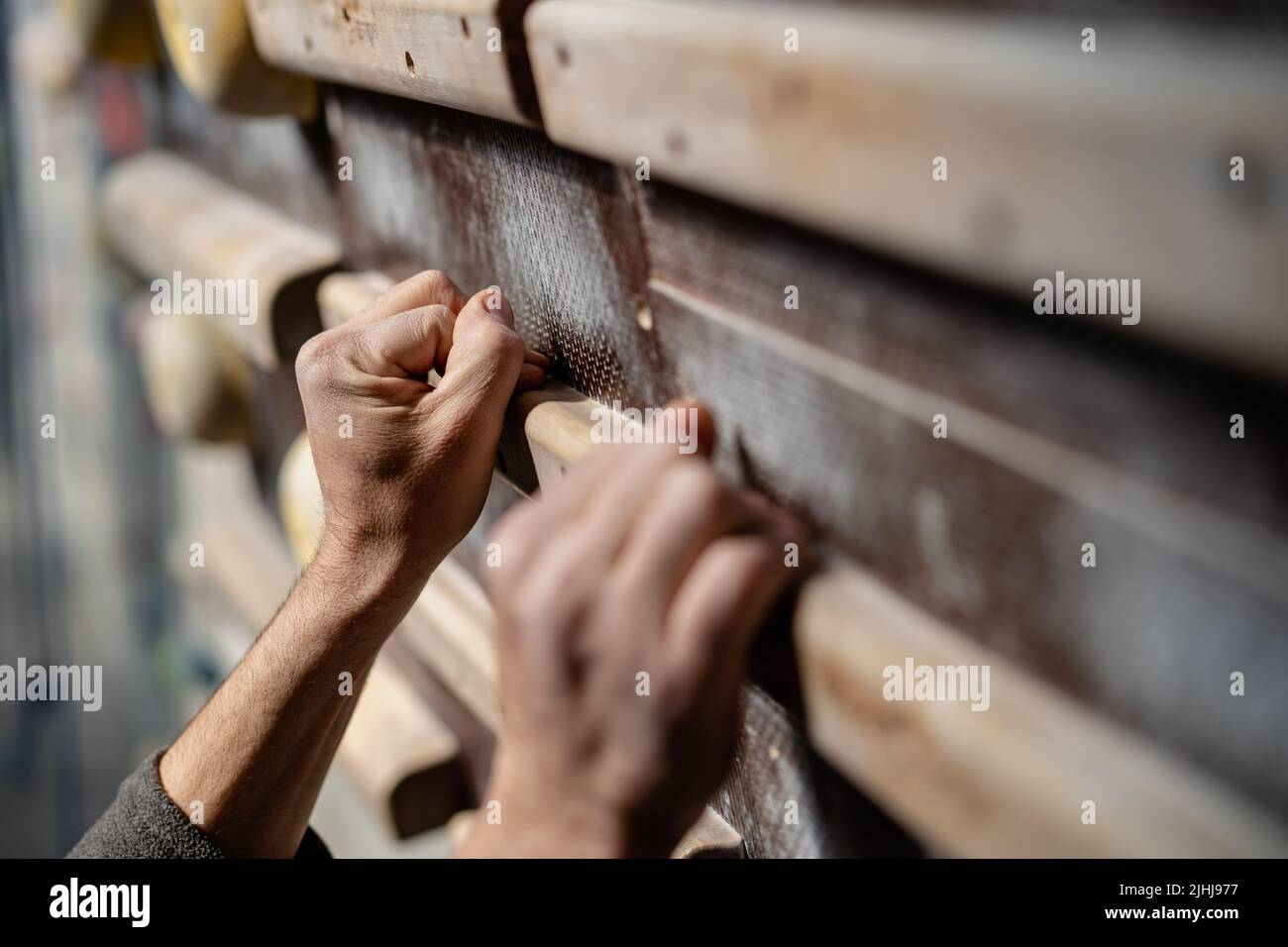 Close up shot of a person's hand holding on to a finger board at a ...