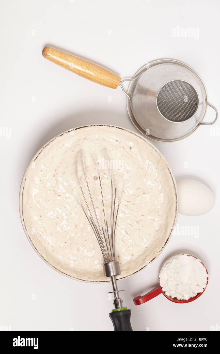 MIxing baking ingredients with dry yeast isolated on white background ...