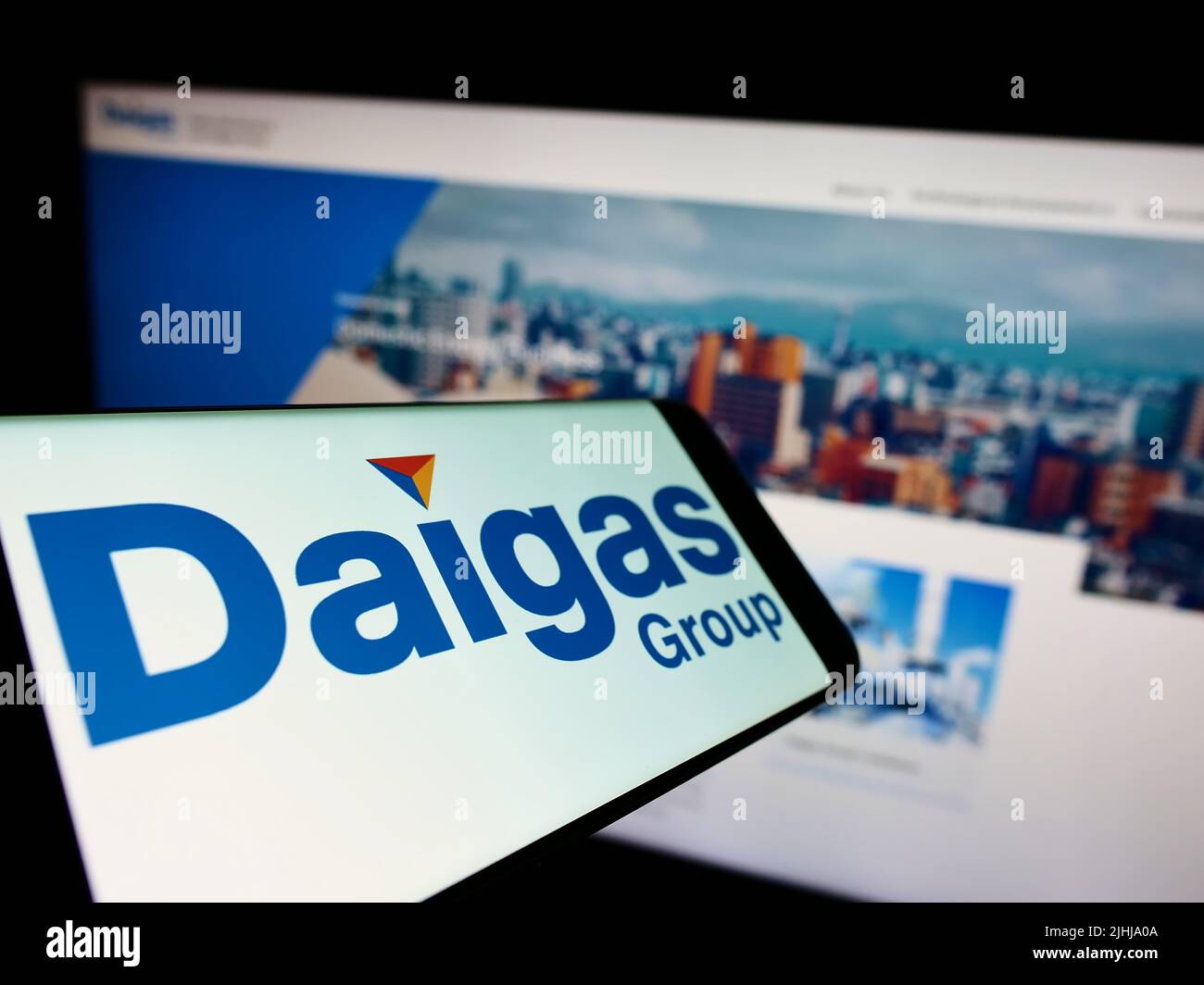 Smartphone with logo of Japanese energy company Daigas Group (Osaka Gas) on screen in front of ...