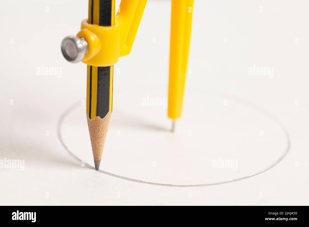 Yellow compass with pencil isolated on white background Stock Photo - Alamy