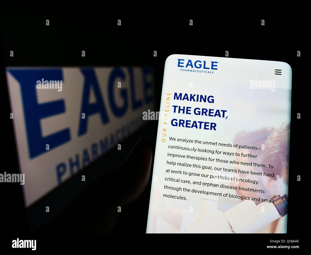 Person holding smartphone with webpage of US company Eagle ...