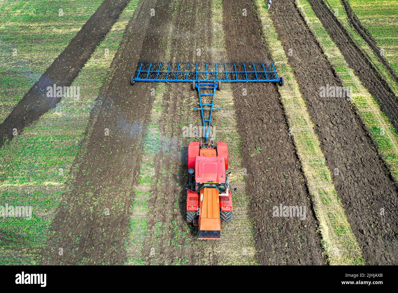 Aerial view drone of harvest field with tractor mows dry grass. Autumn ...