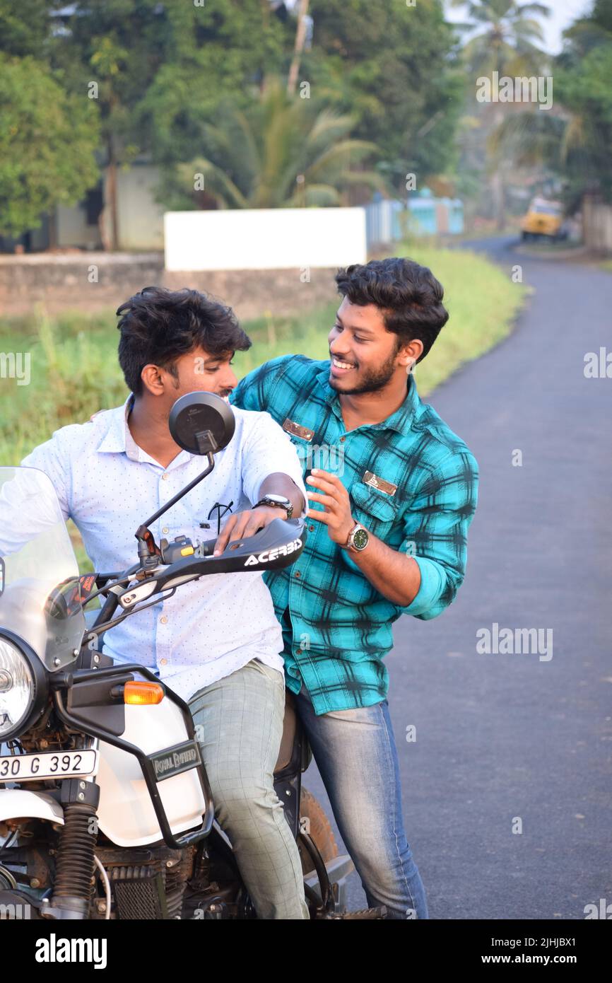 Two friends posing on a motorbike. Concept- travel and friendship Stock ...