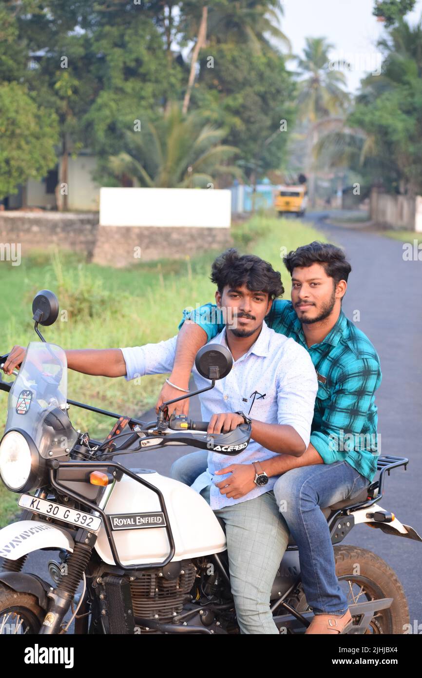 Two friends posing on a motorbike. Concept- travel and friendship Stock ...