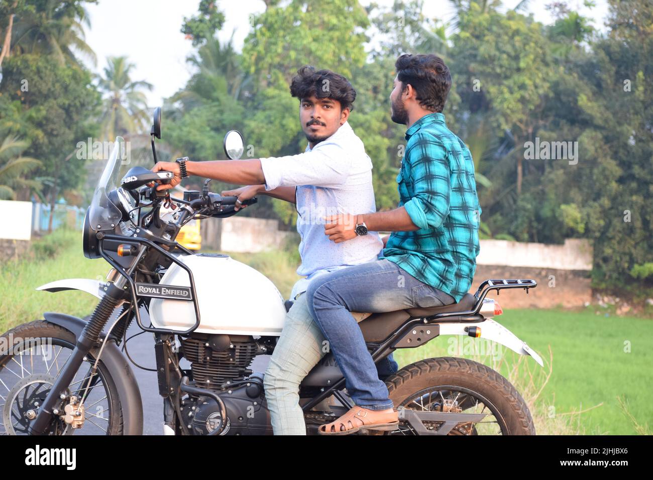 Two friends posing on a motorbike. Concept- travel and friendship Stock ...