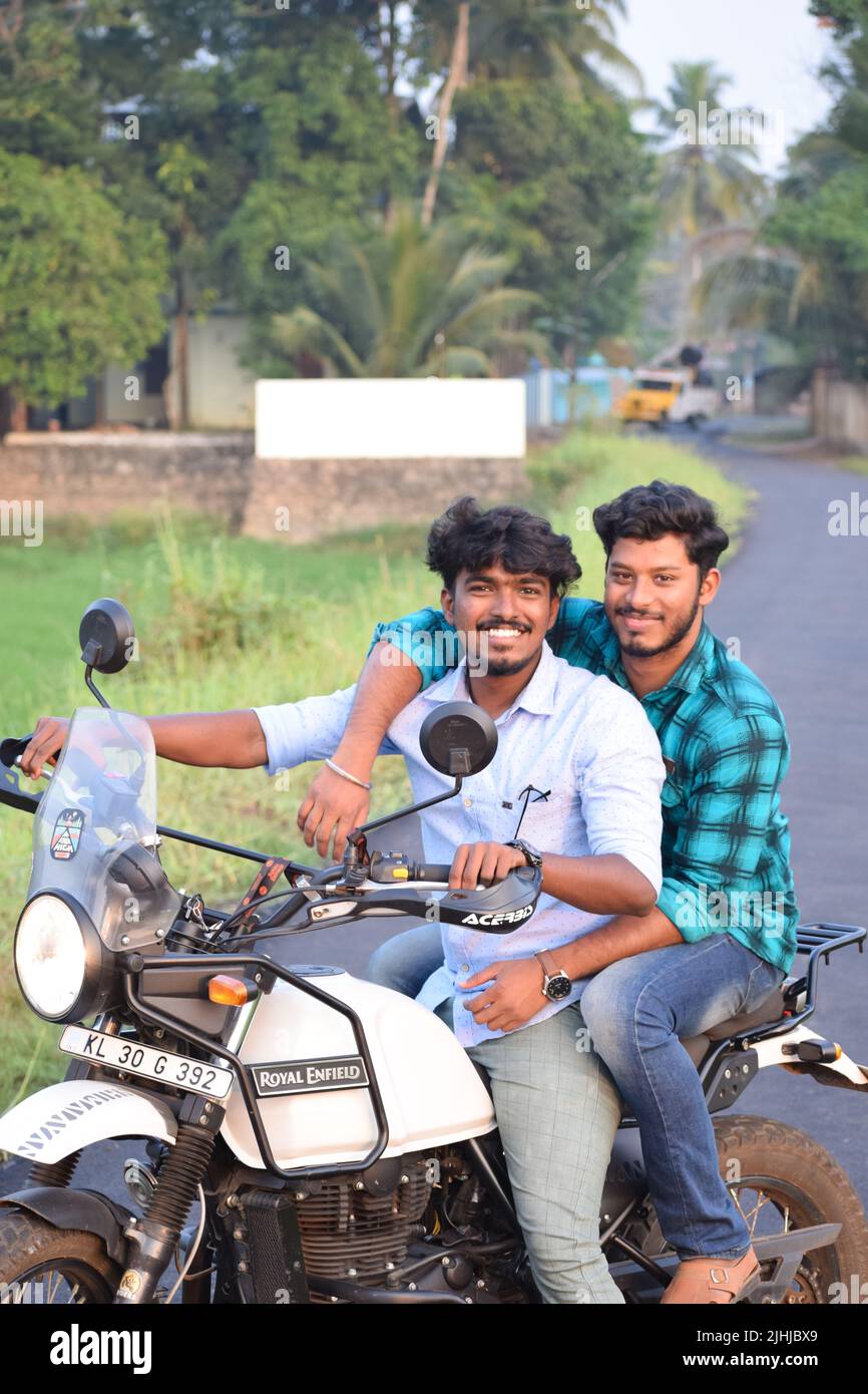 Two friends posing on a motorbike. Concept- travel and friendship Stock ...